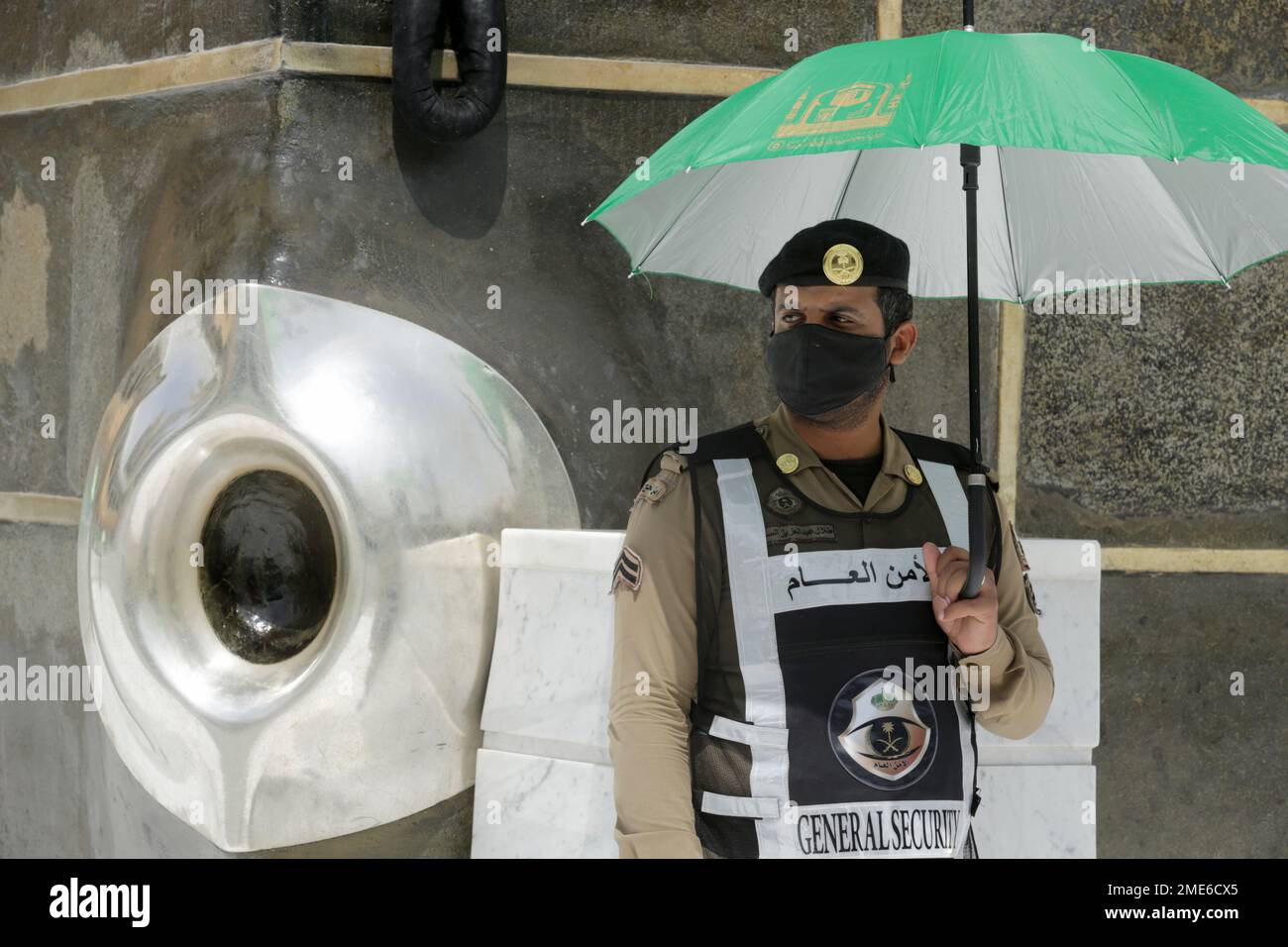 A Saudi policeman stands alert beside Al-Hajar al-Aswad, the black ...