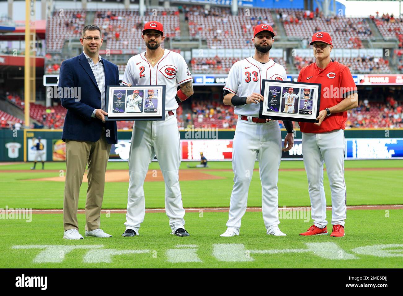 Cincinnati Reds' general manager Nick Krall, left, presents an All-Star ...