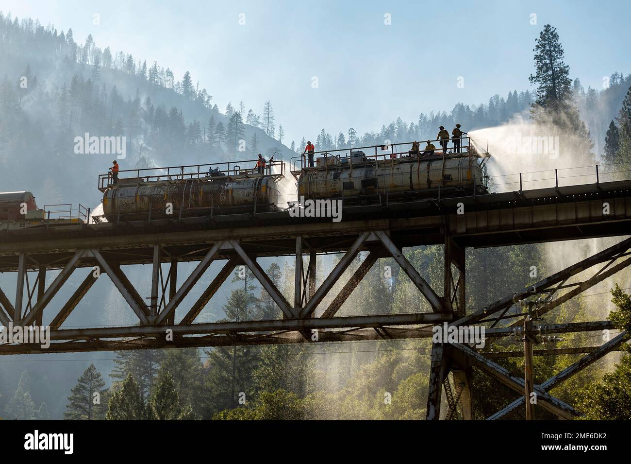 Firefighters spray water from Union Pacific Railroad's fire train while ...