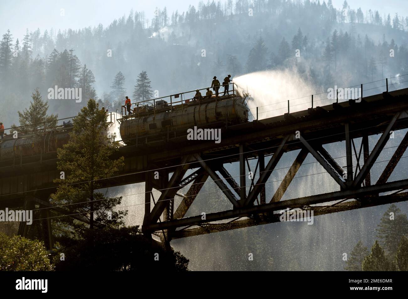 Firefighters spray water from Union Pacific Railroad's fire train while ...