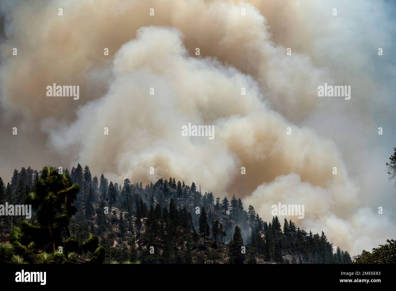 Smoke rises from the Dixie Fire burning along Highway 70 in Plumas ...