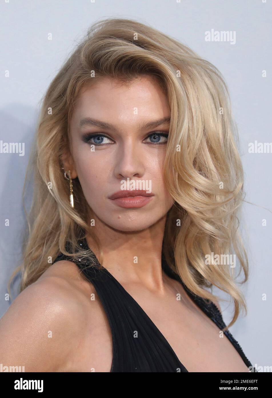 Stella Maxwell poses for photographers upon arrival at the amfAR Cinema ...