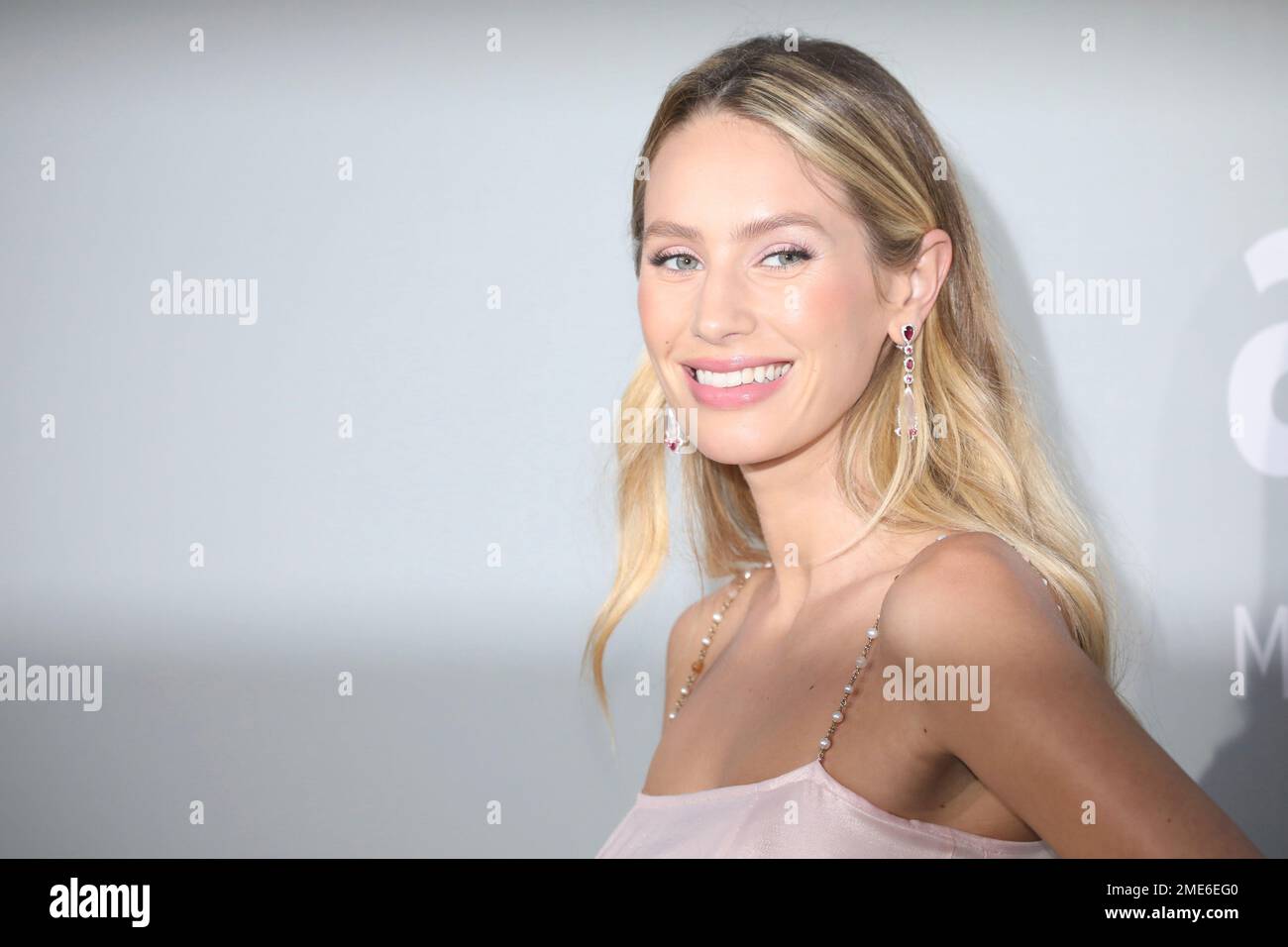 Dylan Penn poses for photographers upon arrival at the amfAR Cinema ...