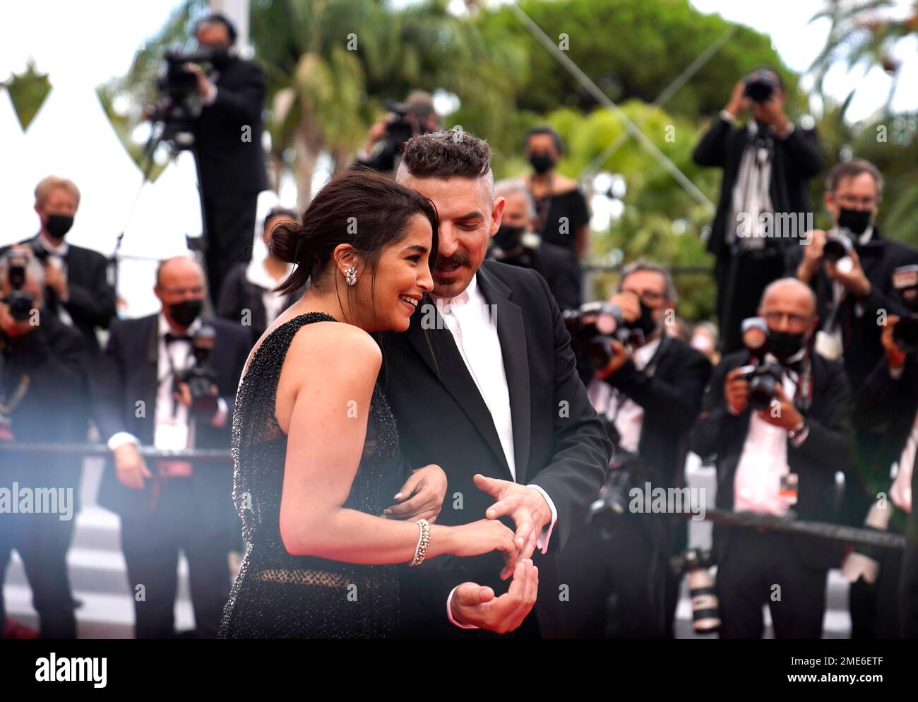 Leila Bekhti, left, and Damien Bonnard pose for photographers upon ...