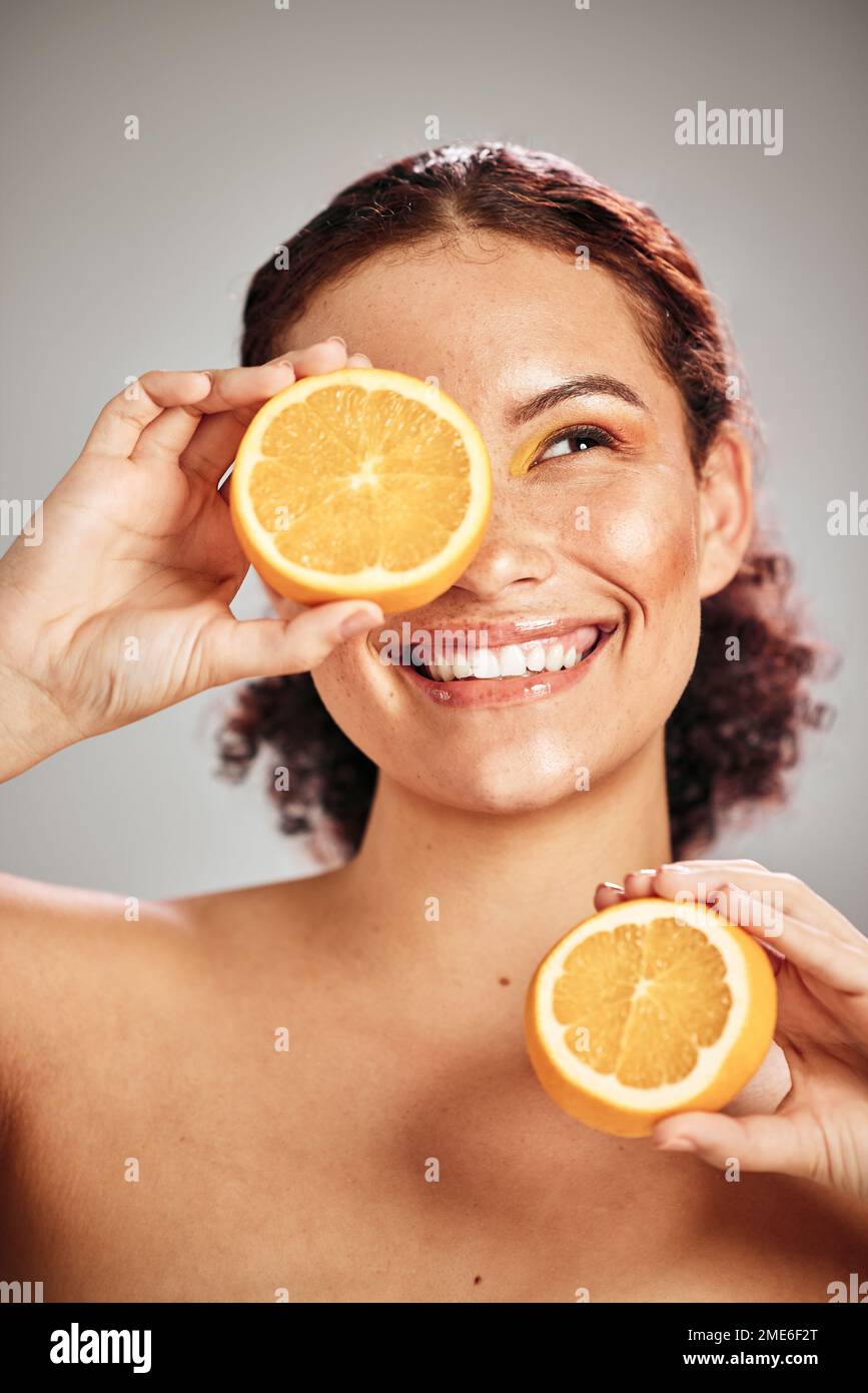 Orange, beauty and woman face in studio with a smile for natural skin ...