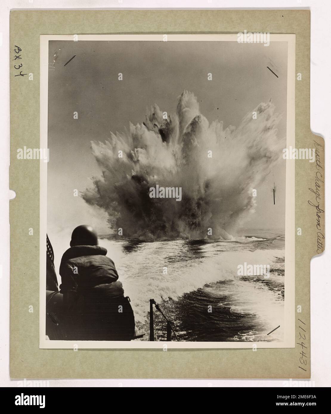 A depth charge explodes beneath the surface, creating a geyser of water ...