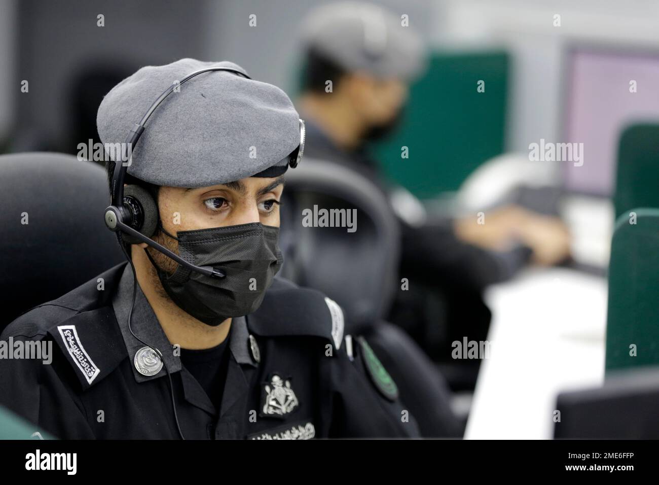 A Saudi policeman receives calls at the National Center for Security ...