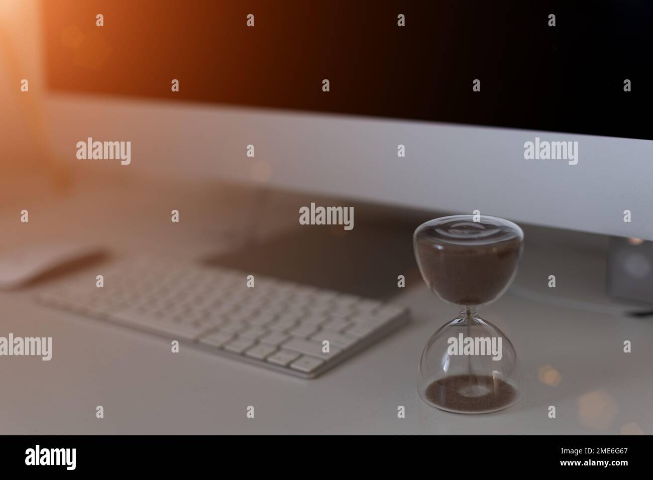 Hourglass on laptop keyboard. Time management concept Stock Photo - Alamy