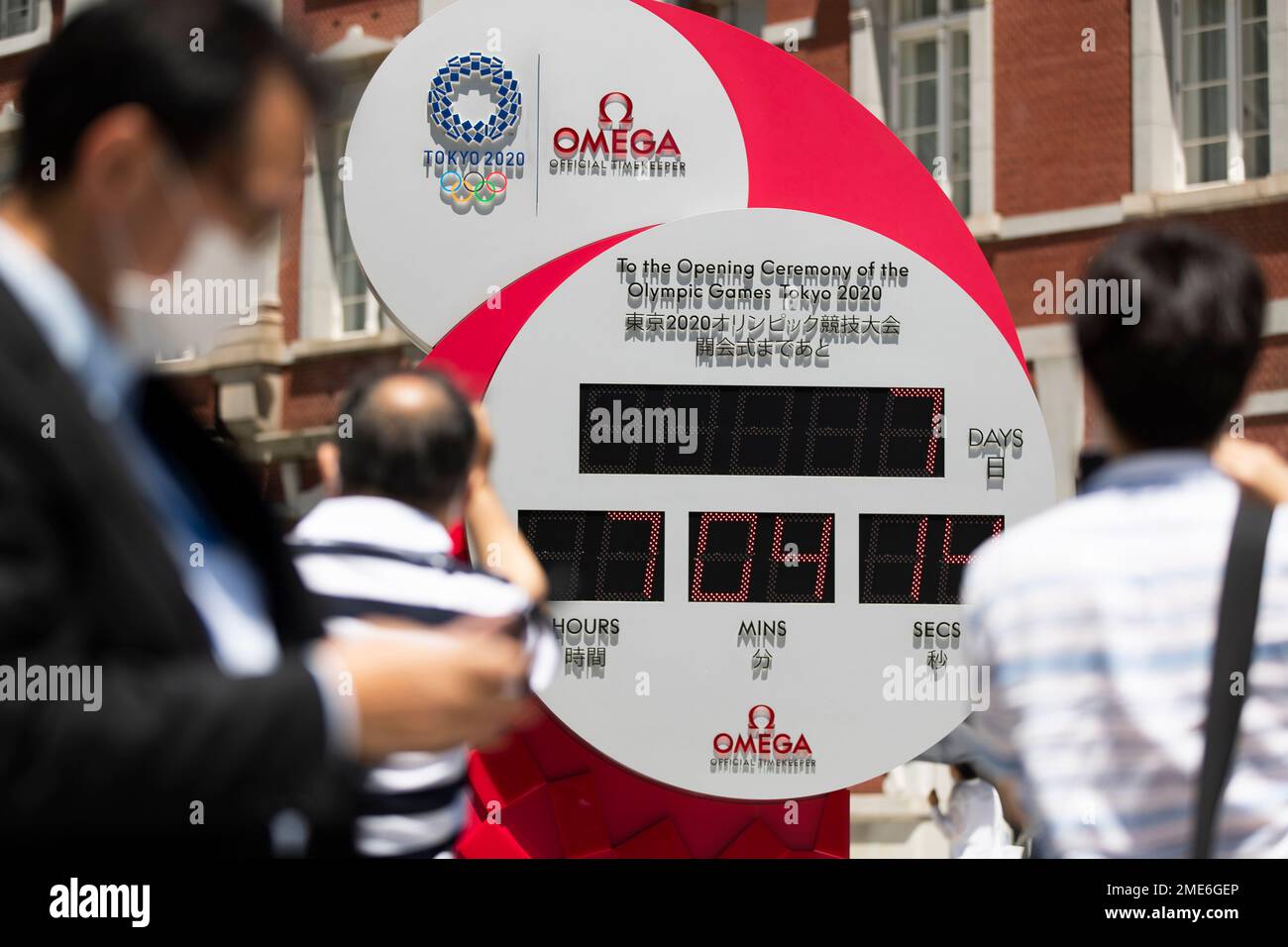 People take pictures of a countdown clock that shows seven more days to ...