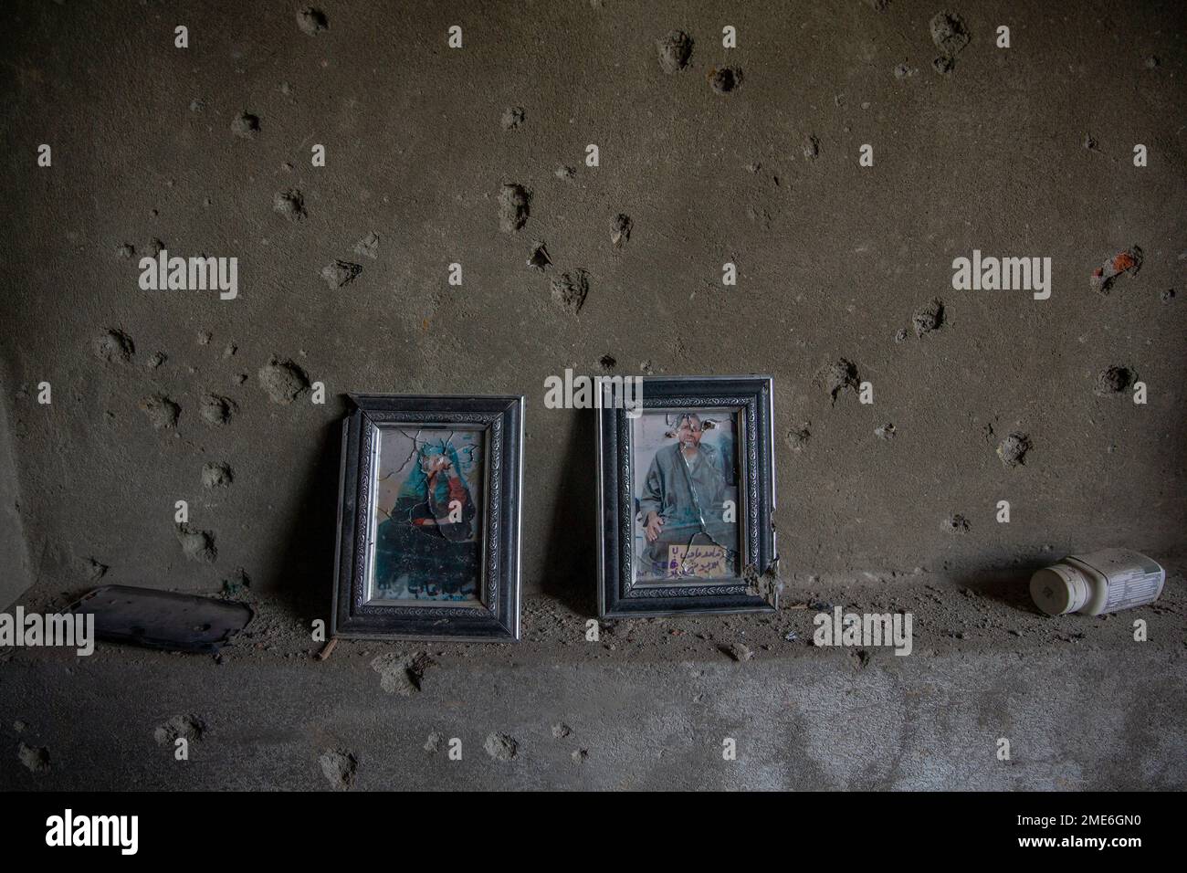 Photographs of Kashmiri Sufi saints are seen on the bullet ridden wall ...