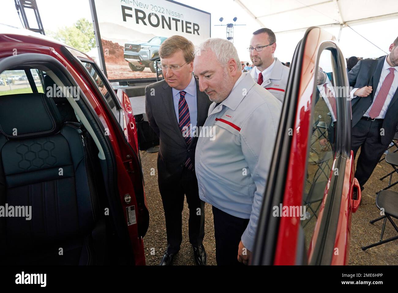 Jérémie Papin, chairperson of Nissan Americas, center, points out ...