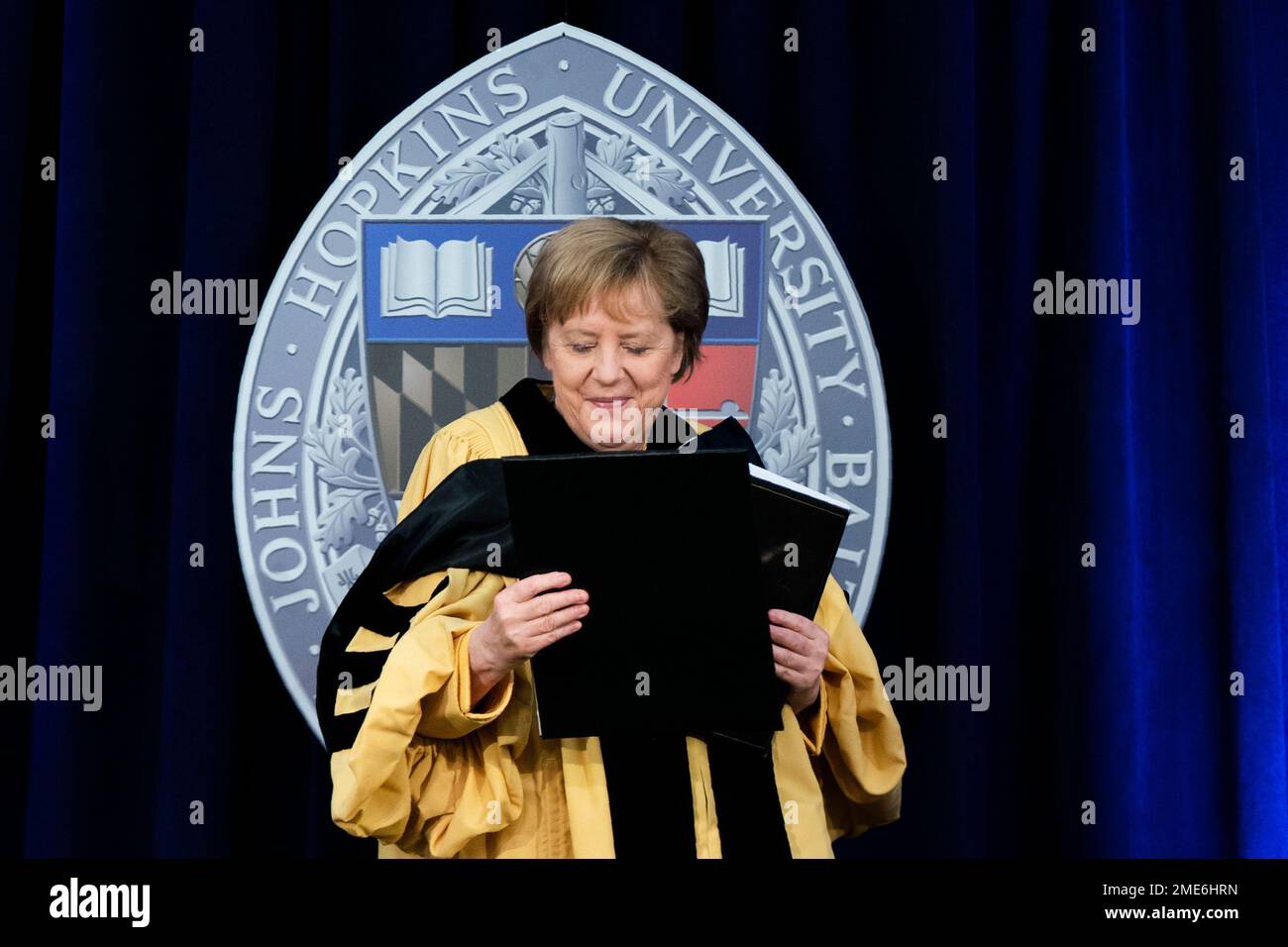German Chancellor Angela Merkel is presented with her diploma as she is ...