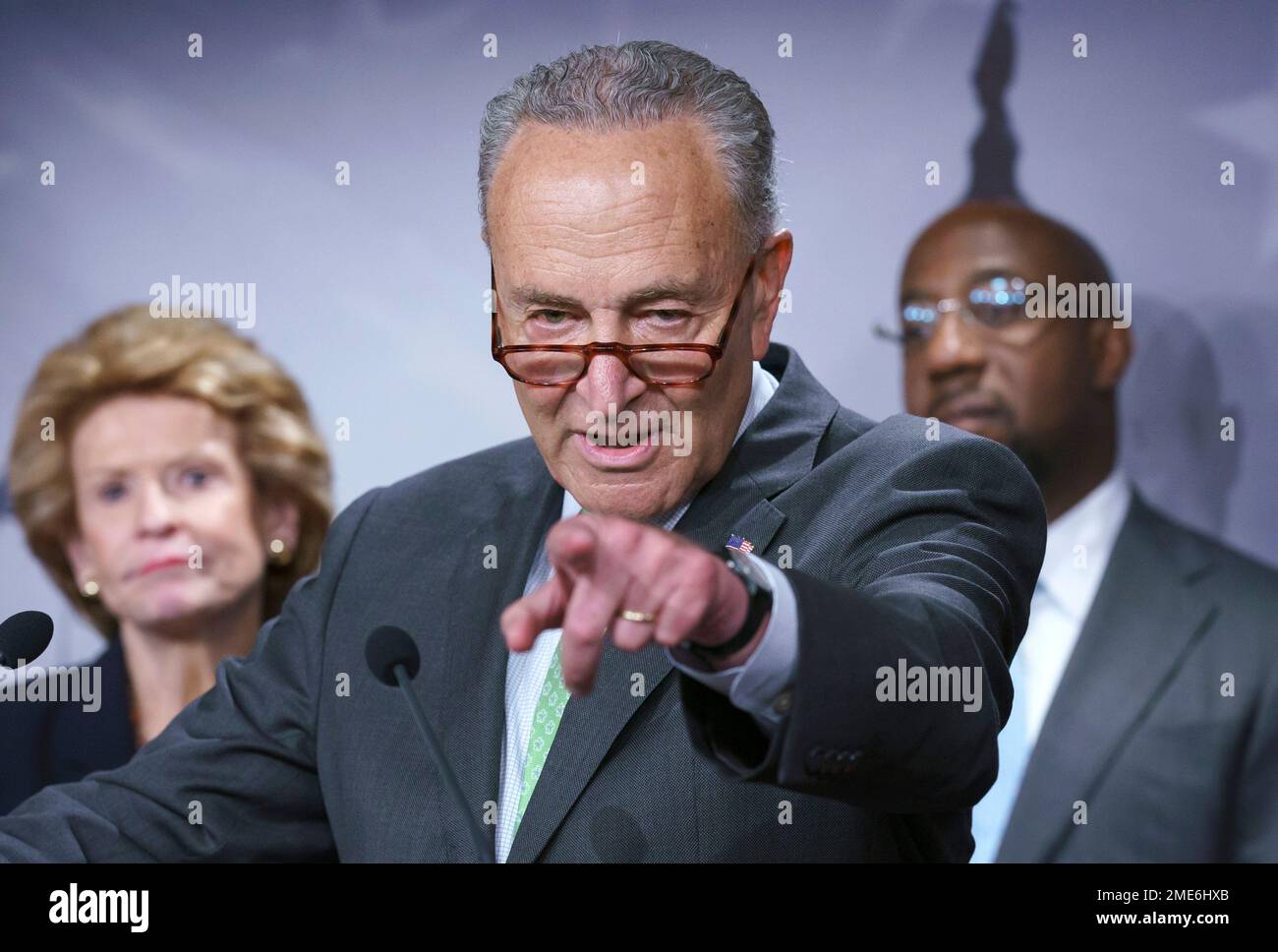 Senate Majority Leader Chuck Schumer, D-N.Y., flanked by Sen. Debbie ...