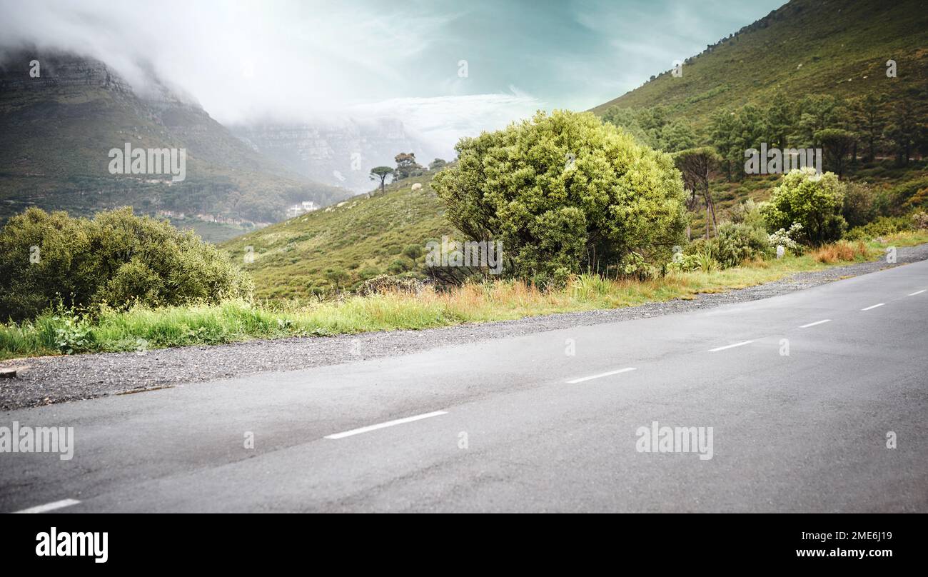 The open road. Still life shot of an empty road alongside a mountain ...