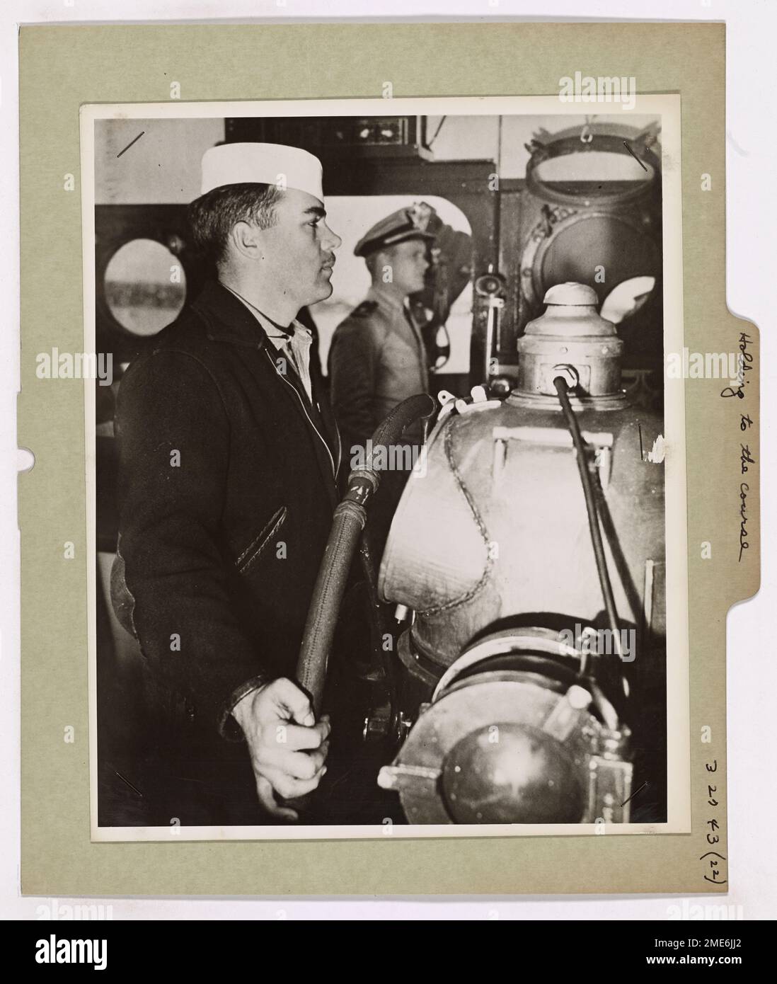 A Coast Guard quartermaster skillfully steers a convoy vessel through ...