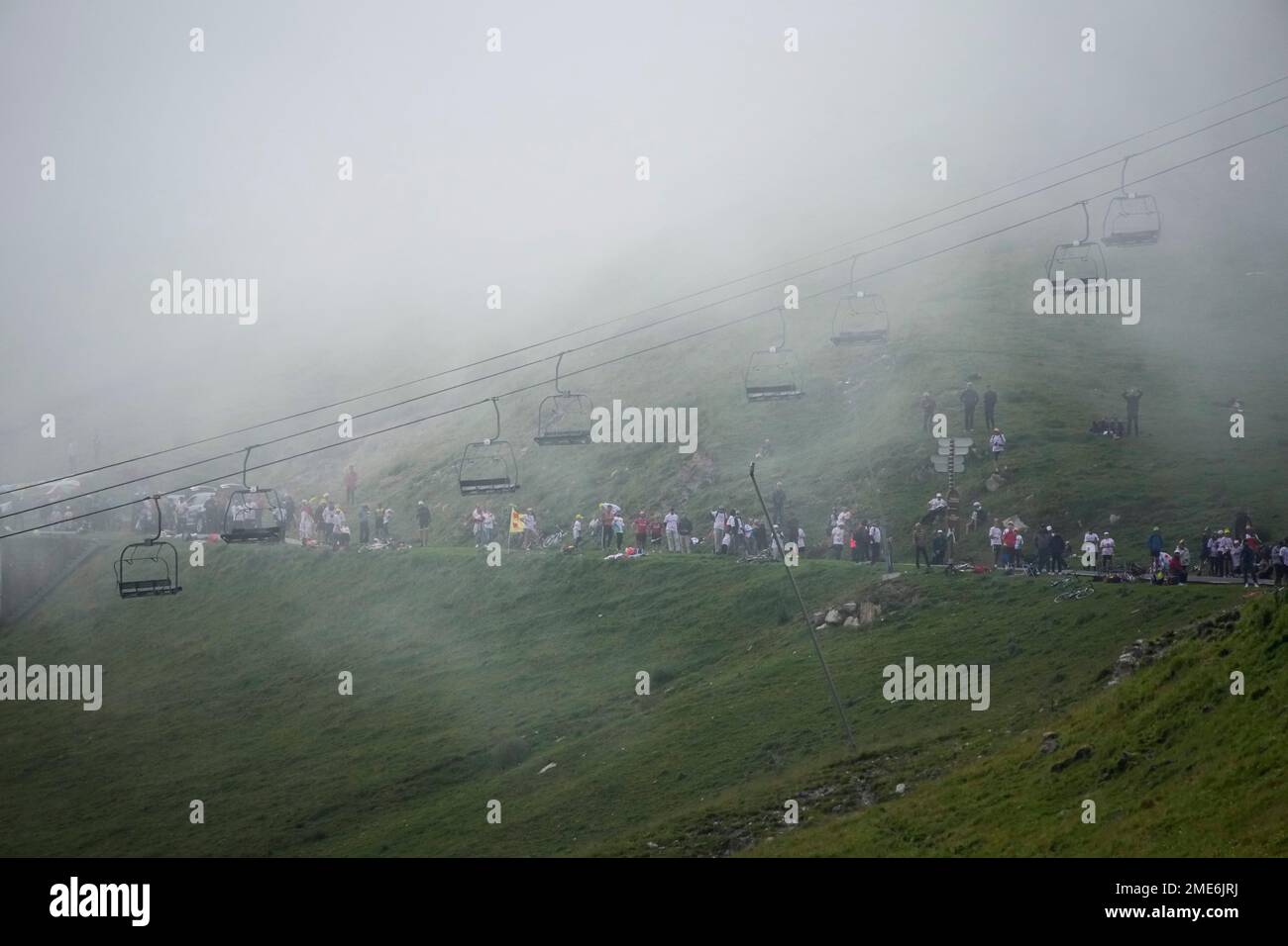 Spectators line the road as they wait for riders to climb Tourmalet ...