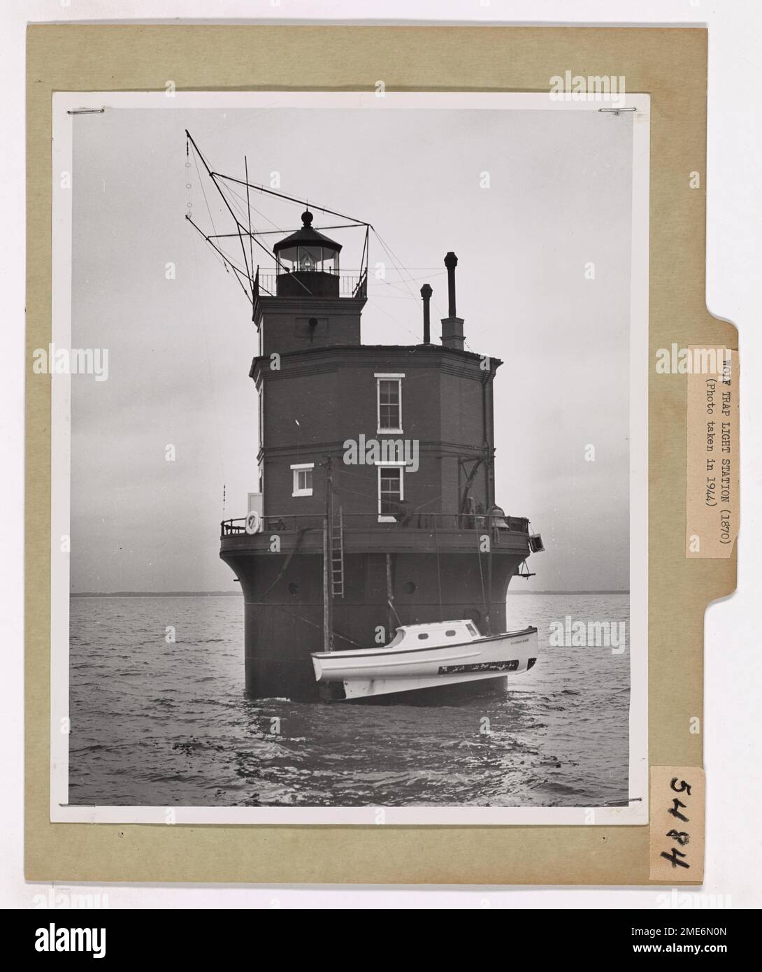 The photograph depicts the Wolf Trap Light Station, established in 1870 ...
