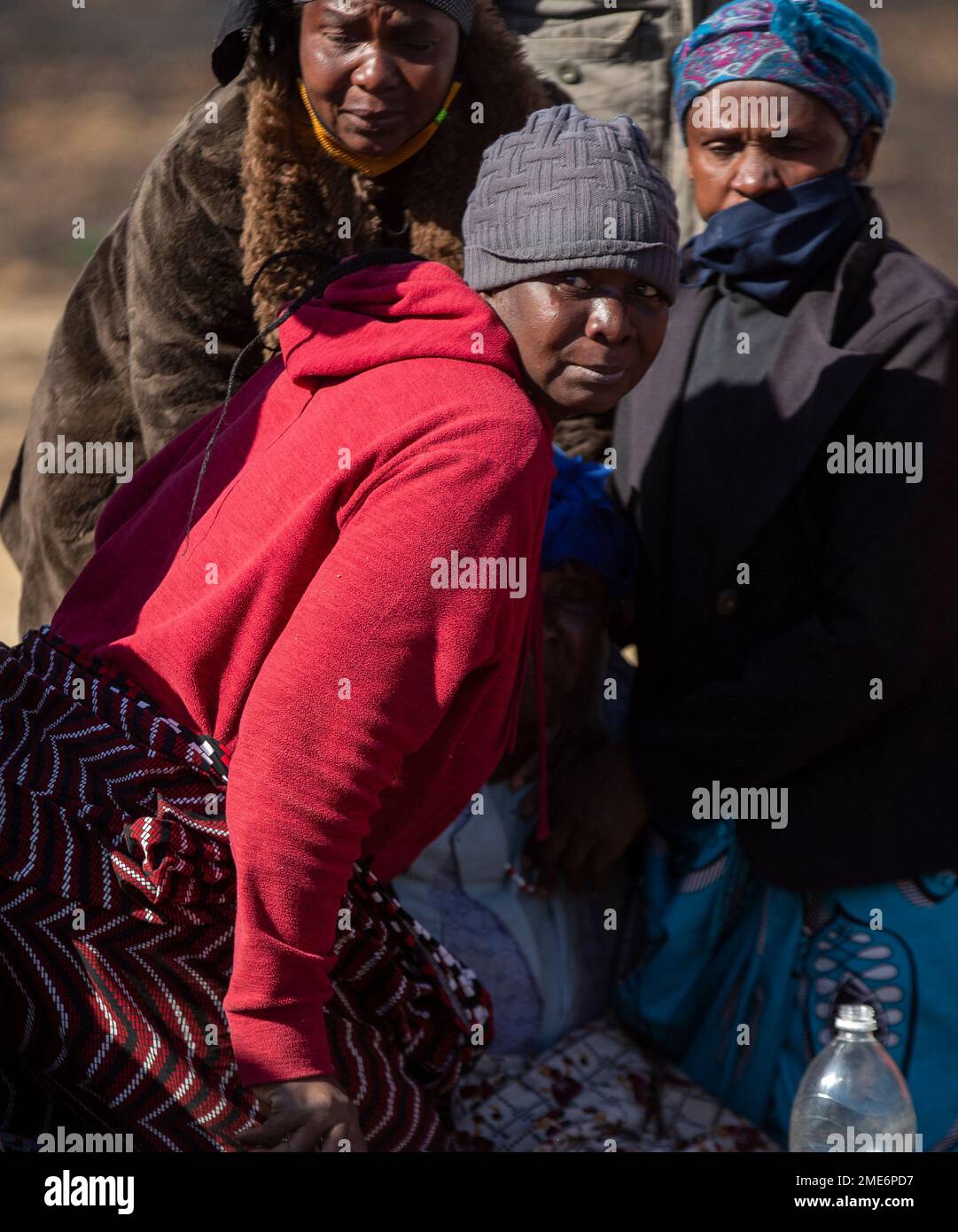 Family members console the grandmother, middle, of Vusi Dlamini, a 14 ...