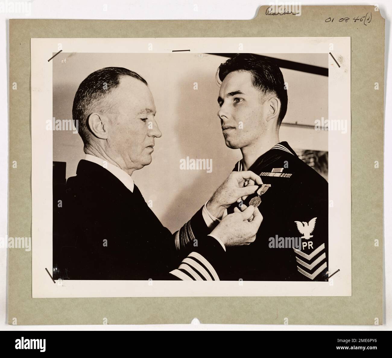 Carter Barber, a Coast Guardsman from Pasadena, California, is awarded the Navy and Marine Corps ...