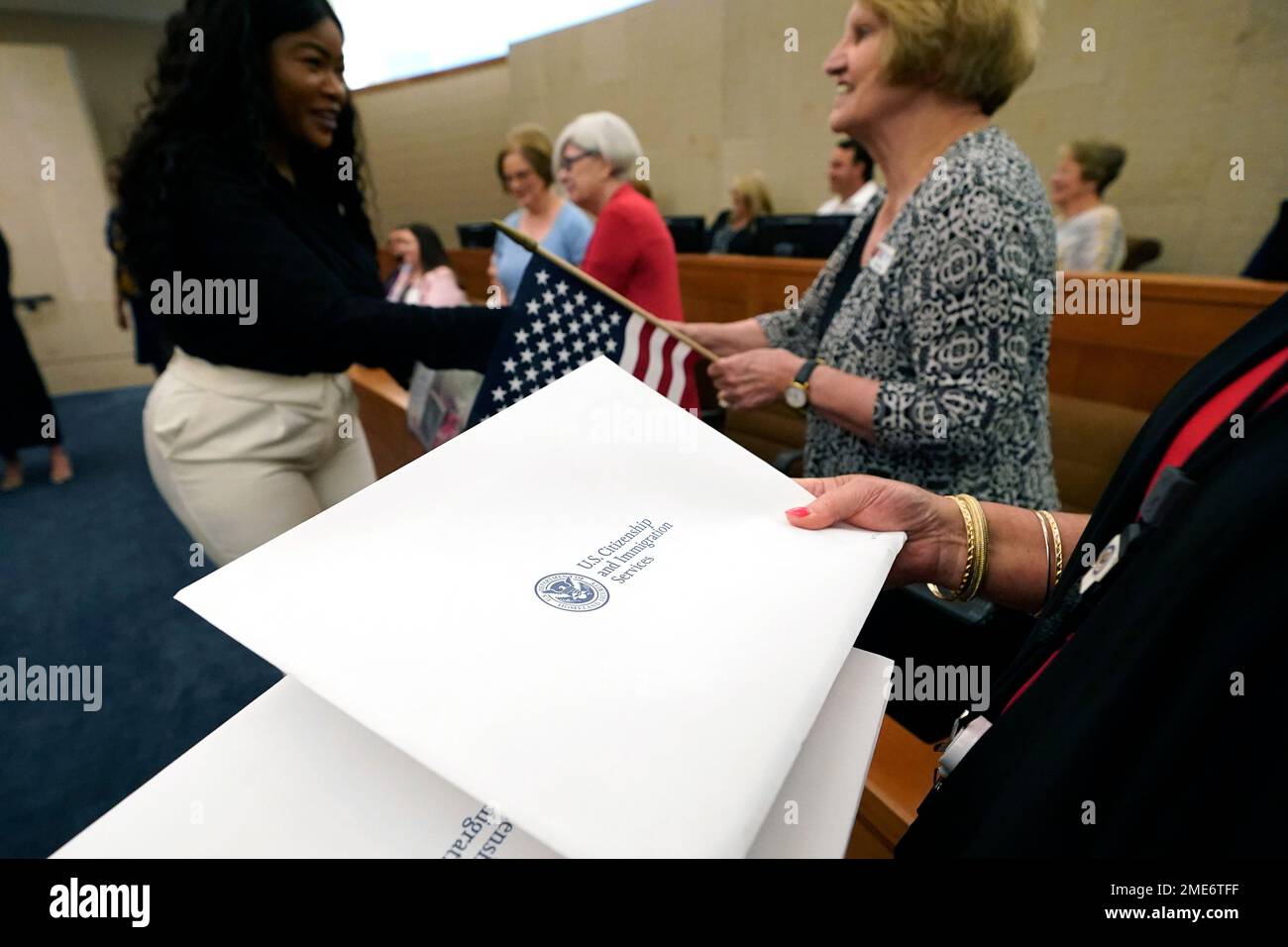 Londiwe S Masango Pyron, receives an American flag from Jane Locke, a ...