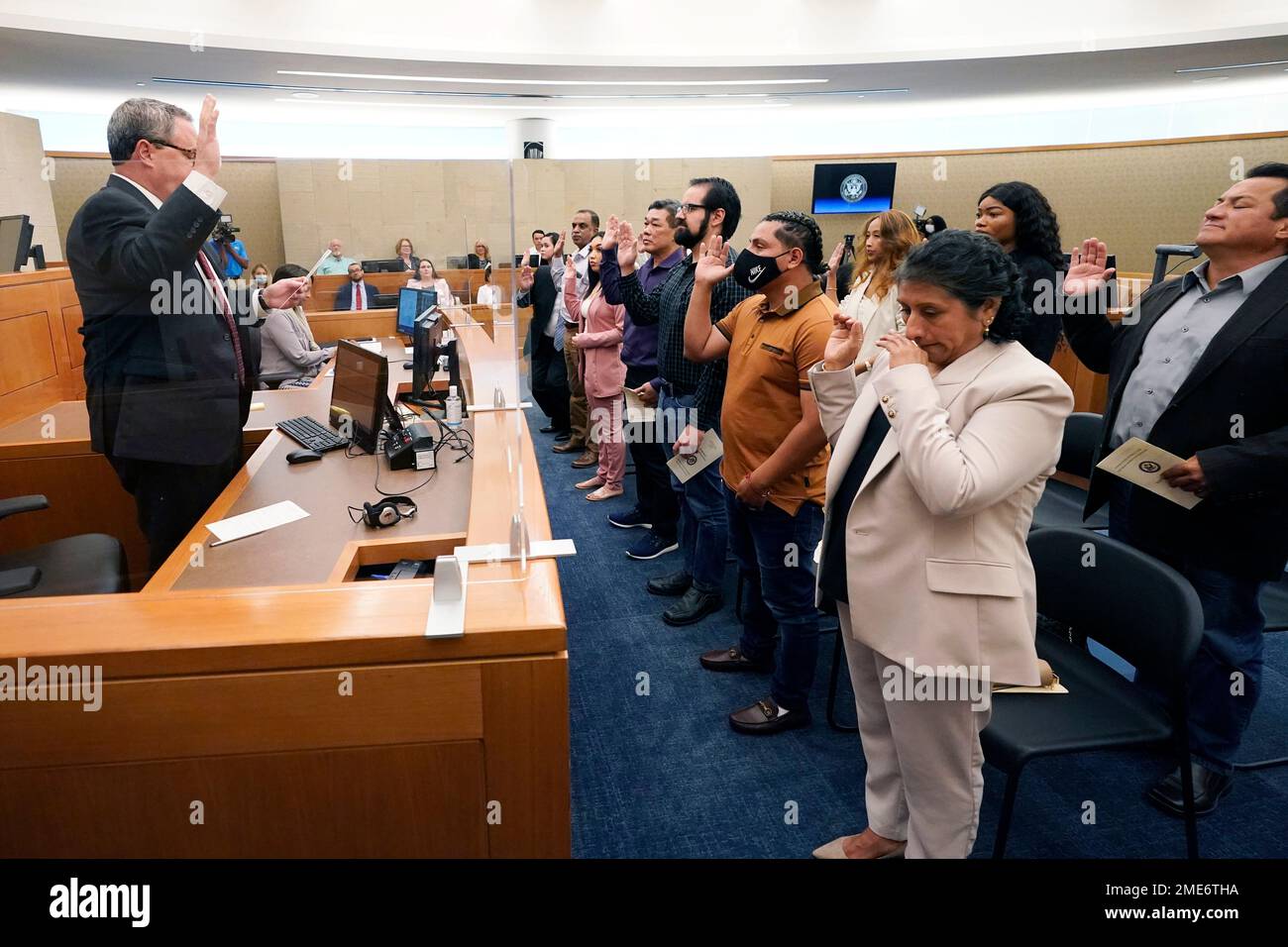 Arthur Johnston, a Clerk of U.S. District Court, left, officiates the ...