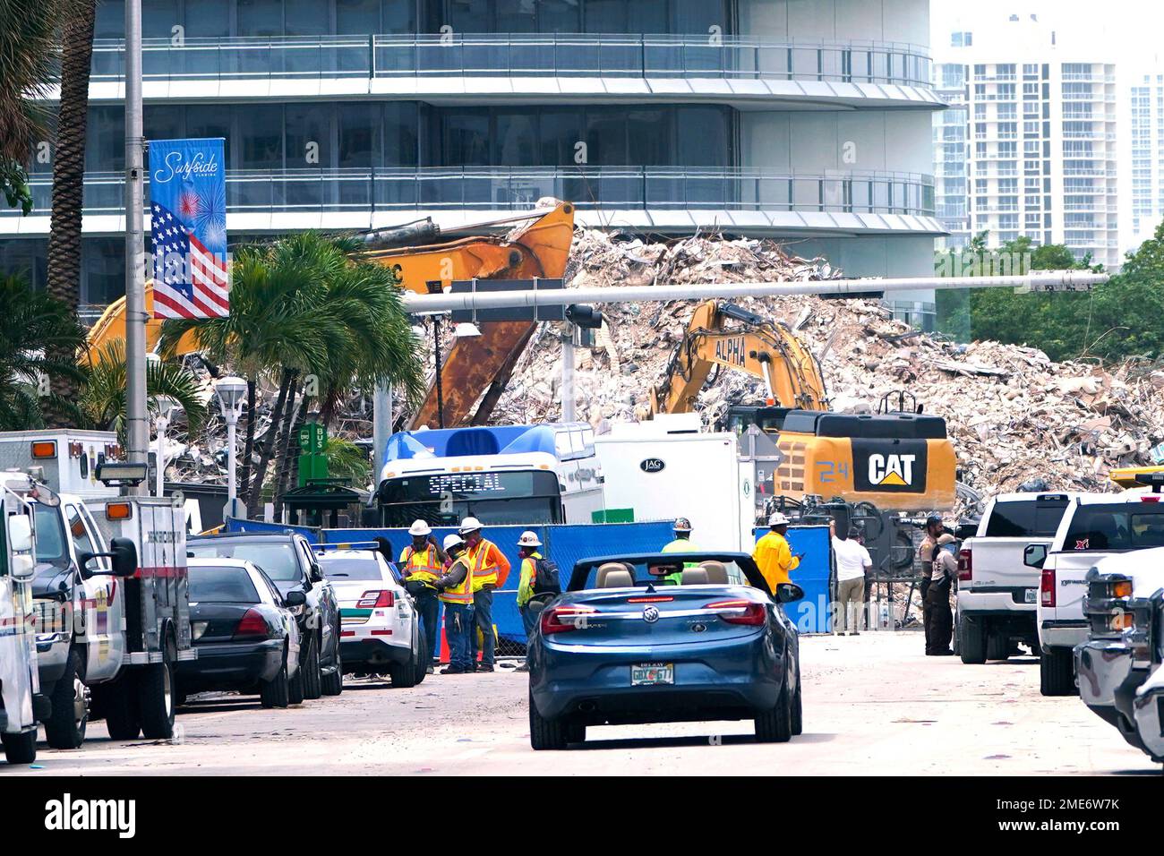 Crews work in the rubble of the Champlain Towers South building, as ...