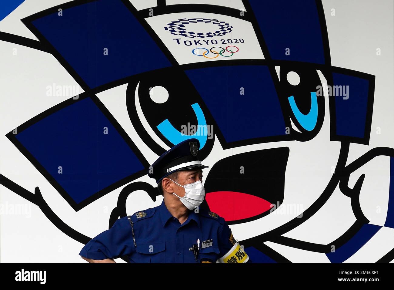 A security guard wearing a mask to help protect against the spread of the coronavirus stands at ...