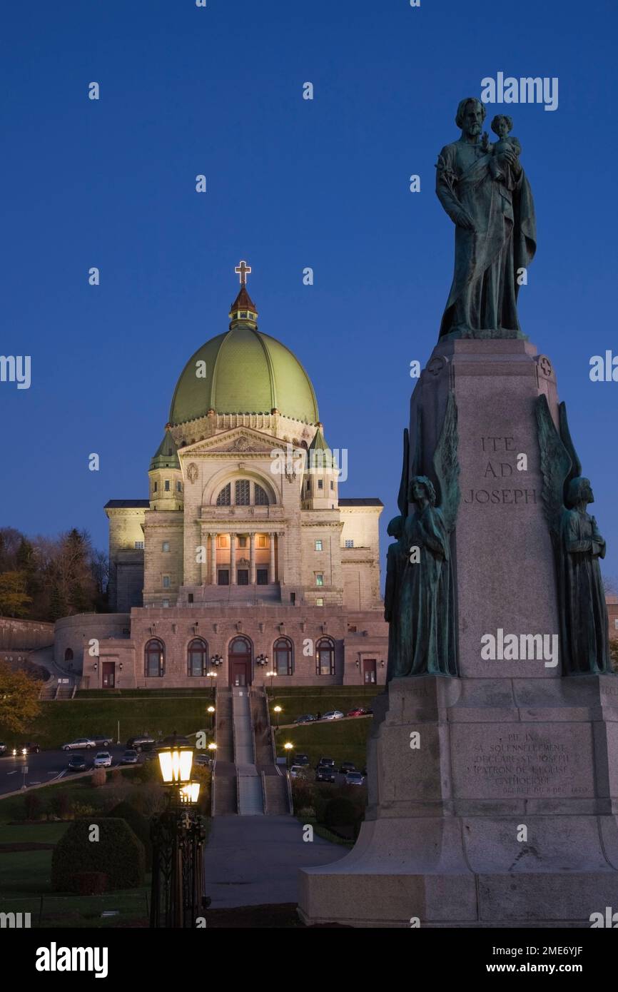 Religious Statue and Saint-Joseph's Oratory illuminated at dusk ...