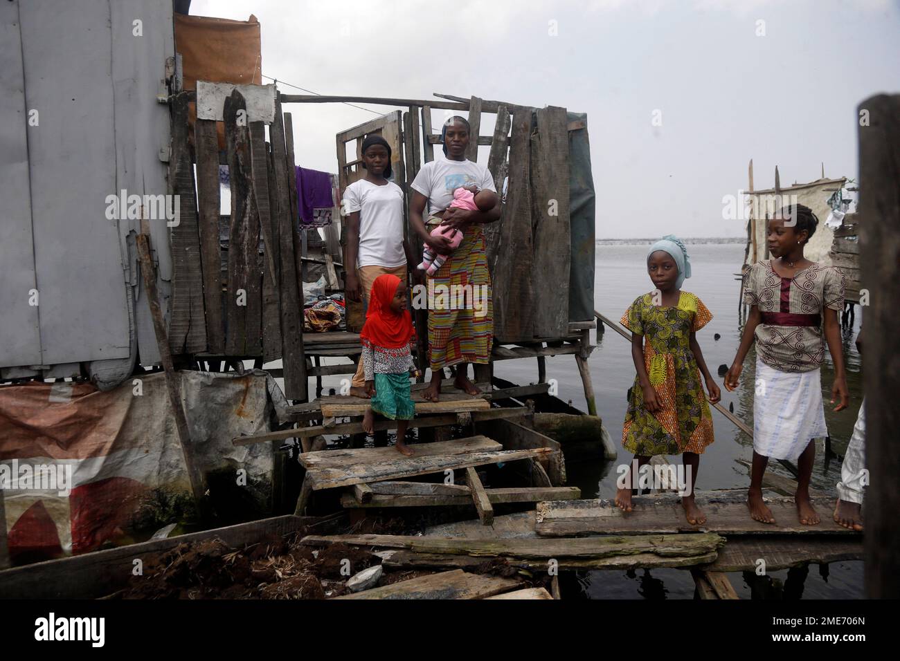 Residents of Oworonshoki Slum stand outside there house in Lagos ...