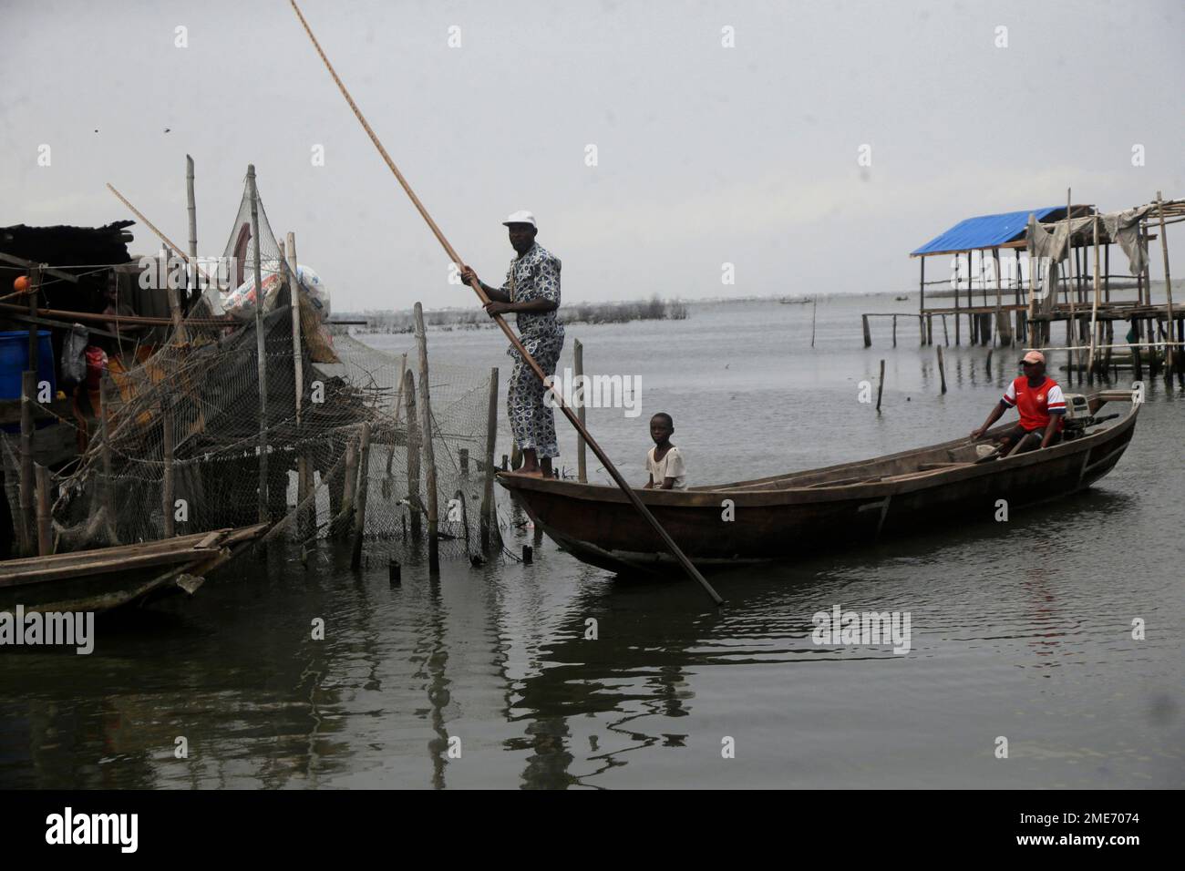 A resident of Oworonshoki Slum paddle a canoe in Lagos, Nigeria ...