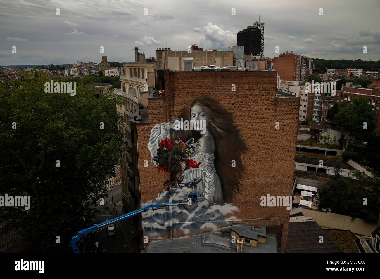 Spanish street artist Lula Goce works in a giant mural in Brussels ...