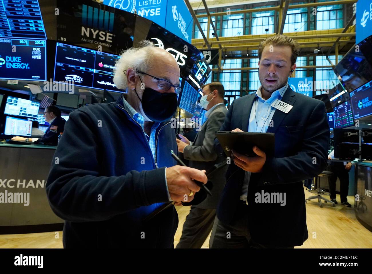 Trader Peter Tuchman, left, and Benjamin Tuchman, father and son, work ...