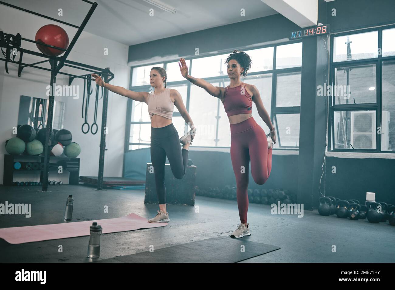 Balance, stretching and friends with women in gym for training, workout ...