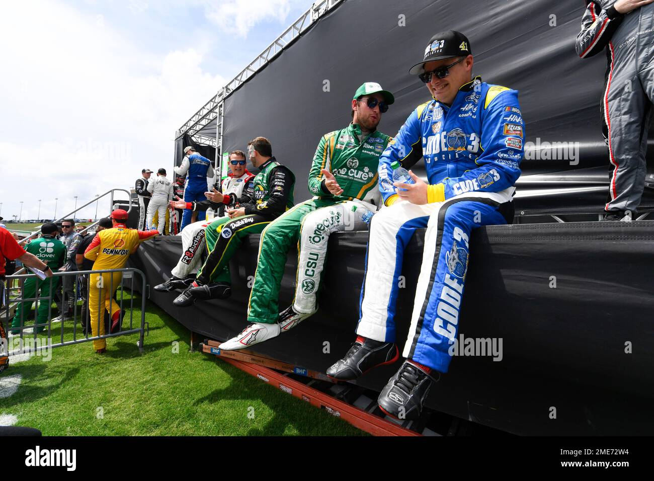 Cole Custer, right, and Chase Briscoe talk as they and other drivers ...