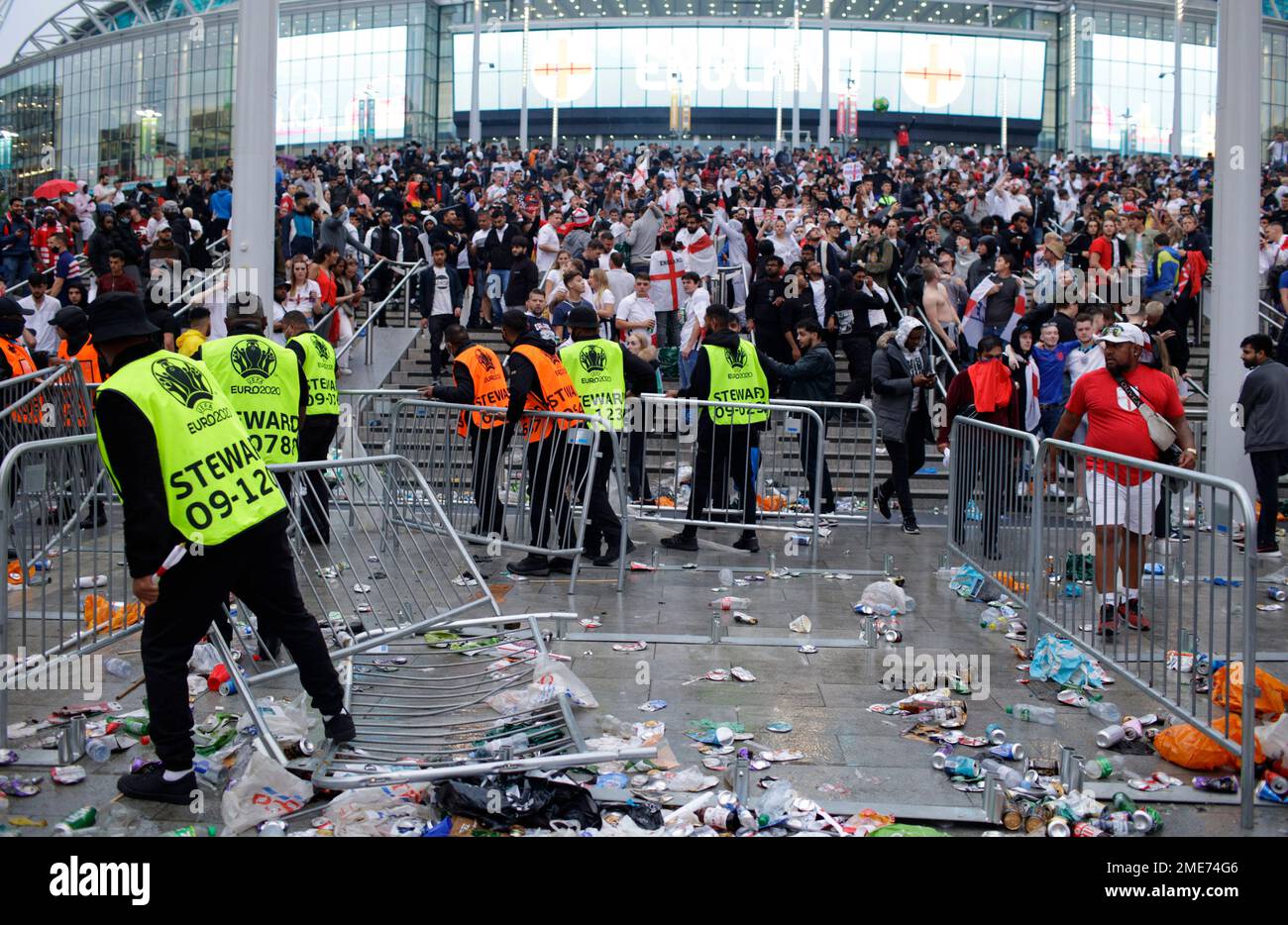 Stewards replace barricades after they were knocked over by supporters ...