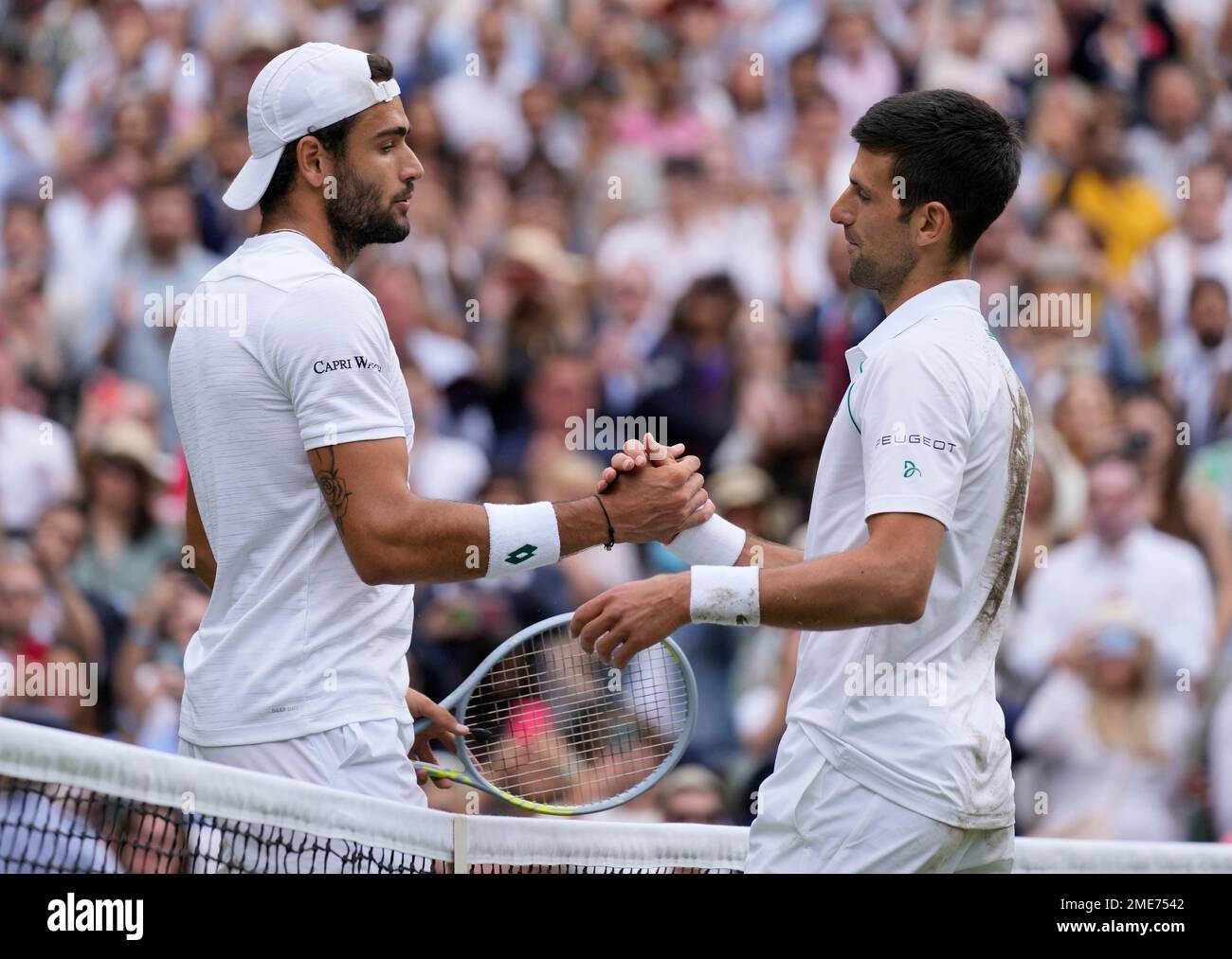 Serbia's Novak Djokovic, right, shakes hands with Italy's Matteo ...