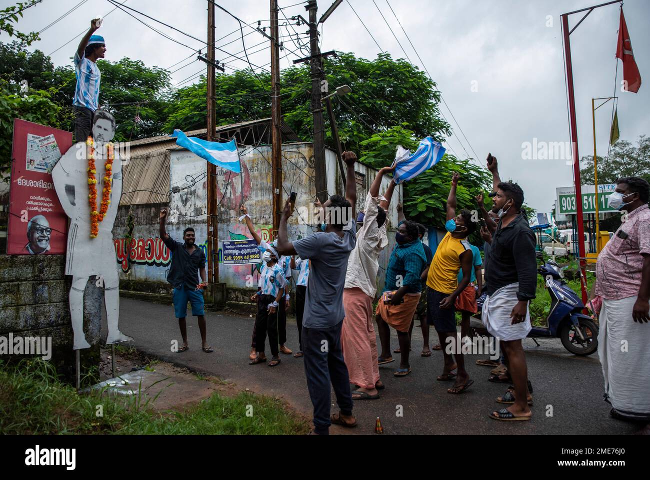 Indian soccer fans garland a cut out photograph of Argentina's Lionel ...