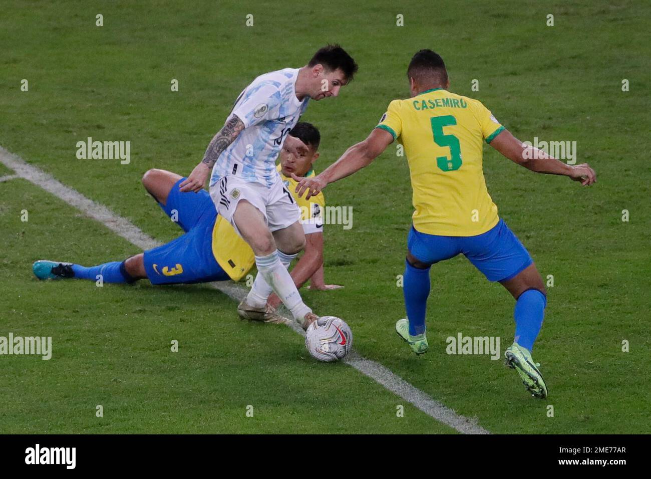 Argentina's Lionel Messi is challenged by Brazil's players Thiago Silva ...