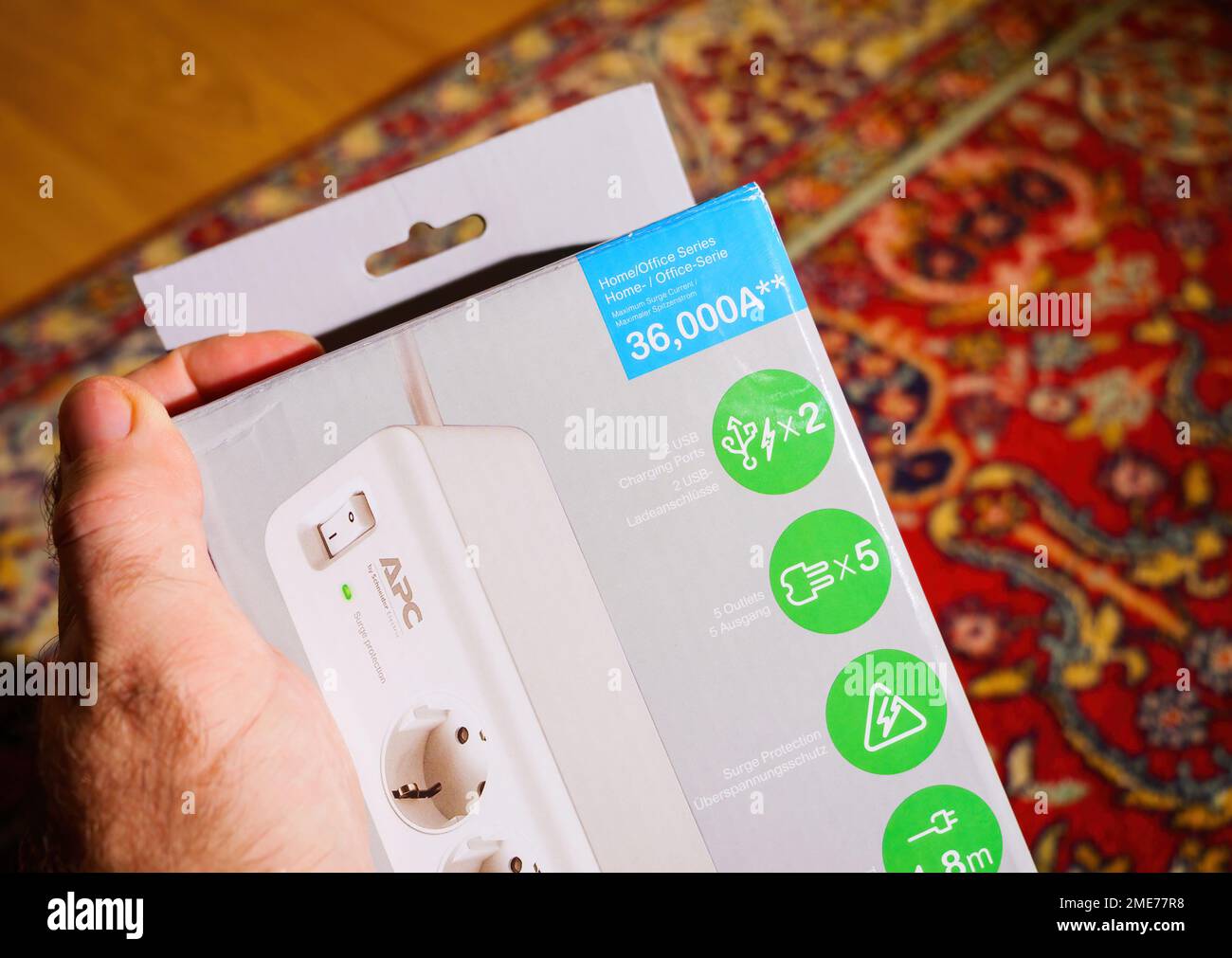 Frankfurt, Germany - Dec 2, 2022: POV male customer hand holding APC American Power Conversion ...