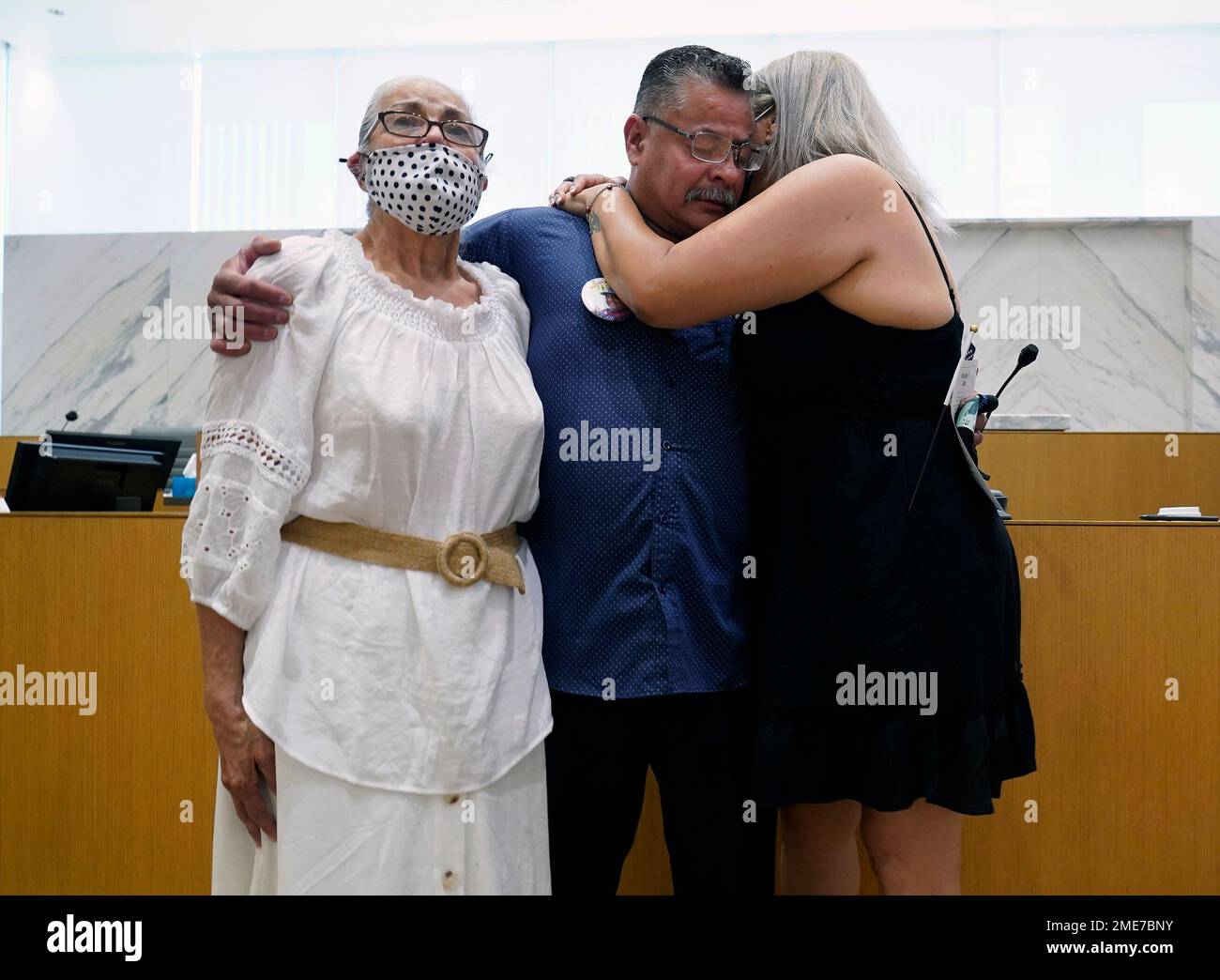 U.S. Marine Corps Hector Ocegueda, middle, is hugged by his sister ...
