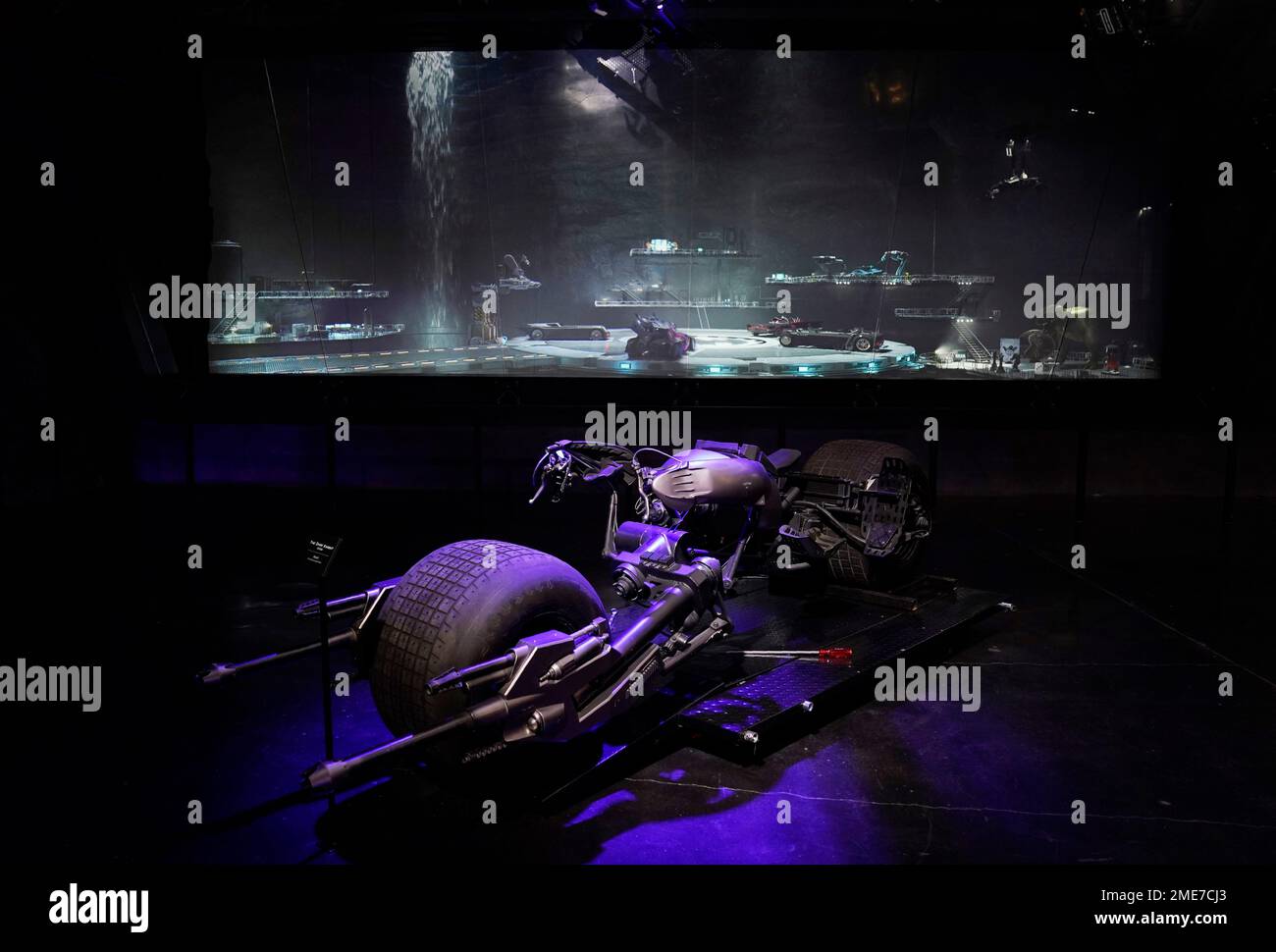 A 3-D rendering of the The Batcave stands behind the Batpod from the ...