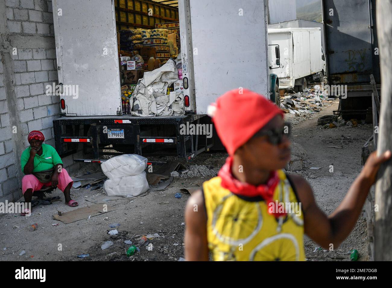 Haitians with trucks loaded with goods wait for the opening of the ...
