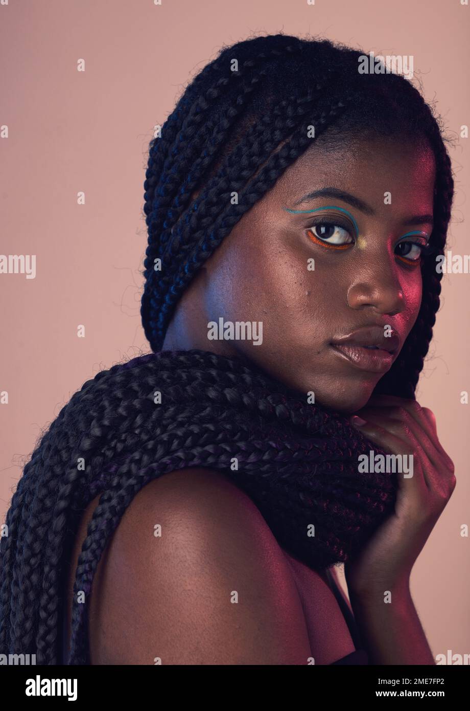 Portrait, hair and makeup with a model black woman in studio on a wall ...