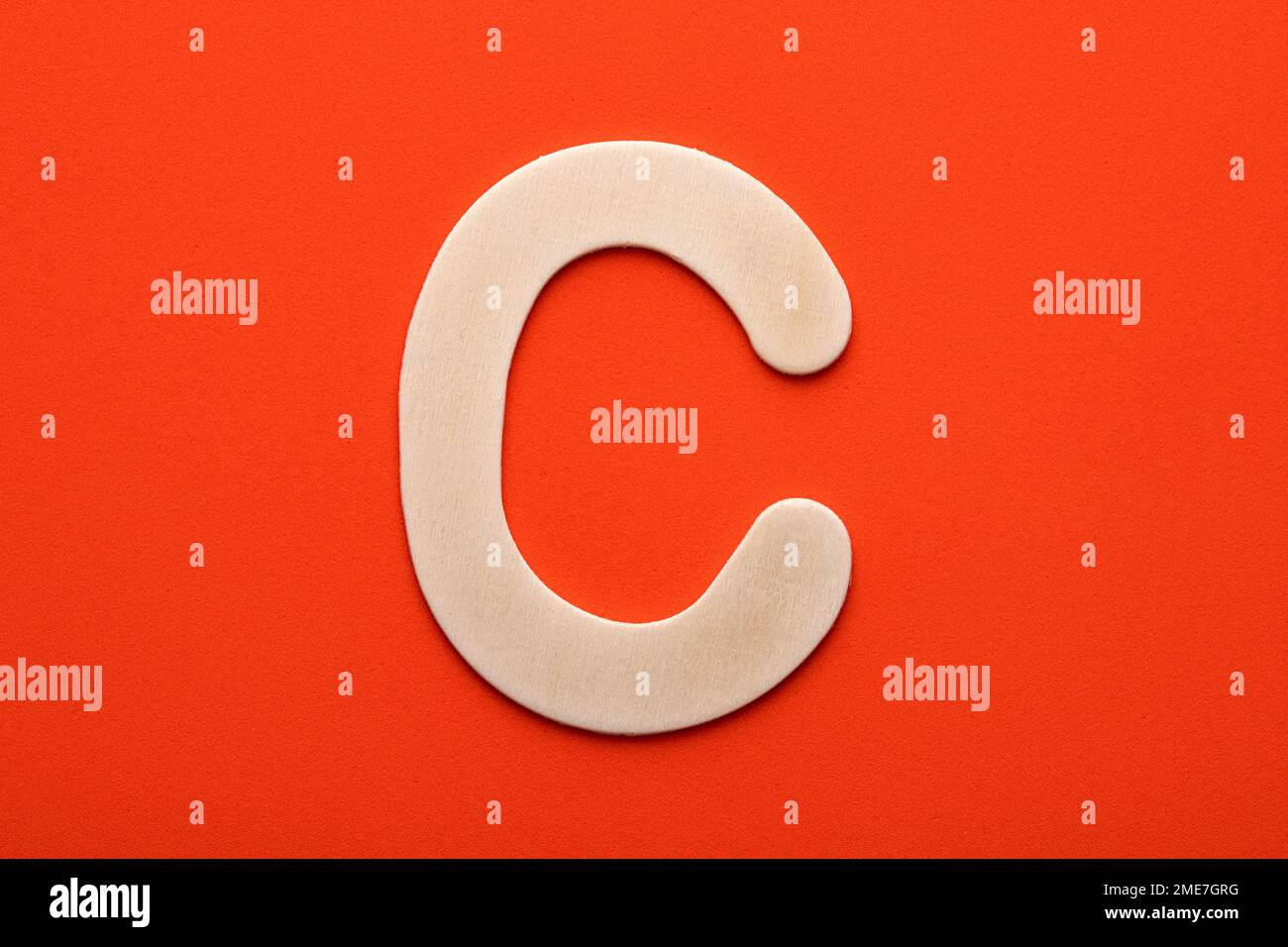 Alphabet letter C - White wood piece on orange foamy background Stock ...