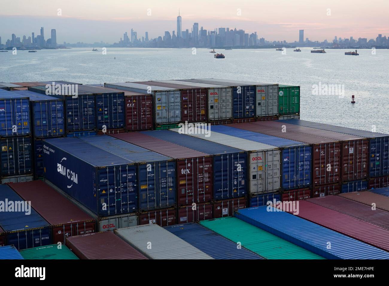 The Manhattan skyline is seen as a container ship makes its way through ...