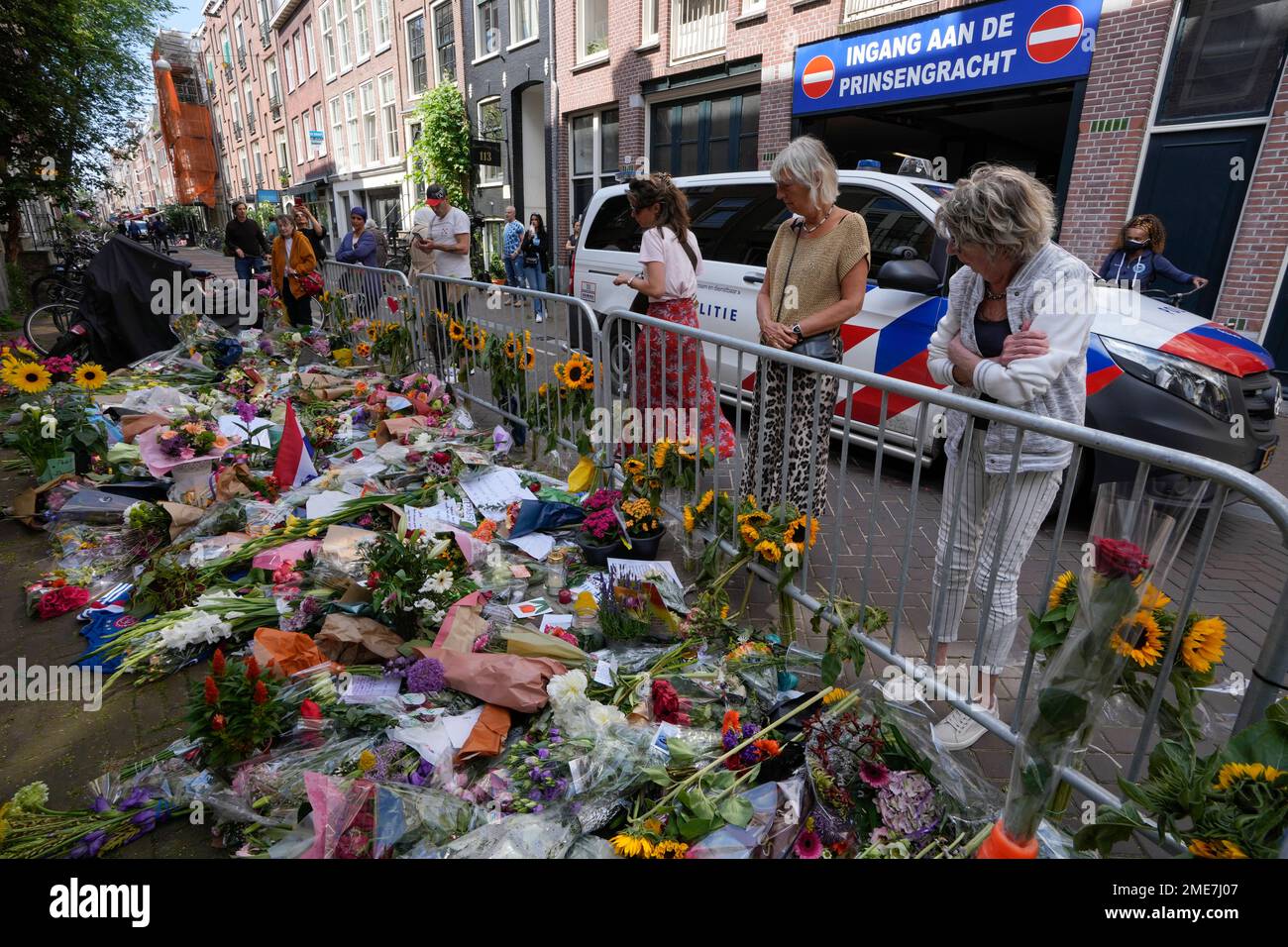 A police car passes flowers which mark the spot where journalist Peter ...