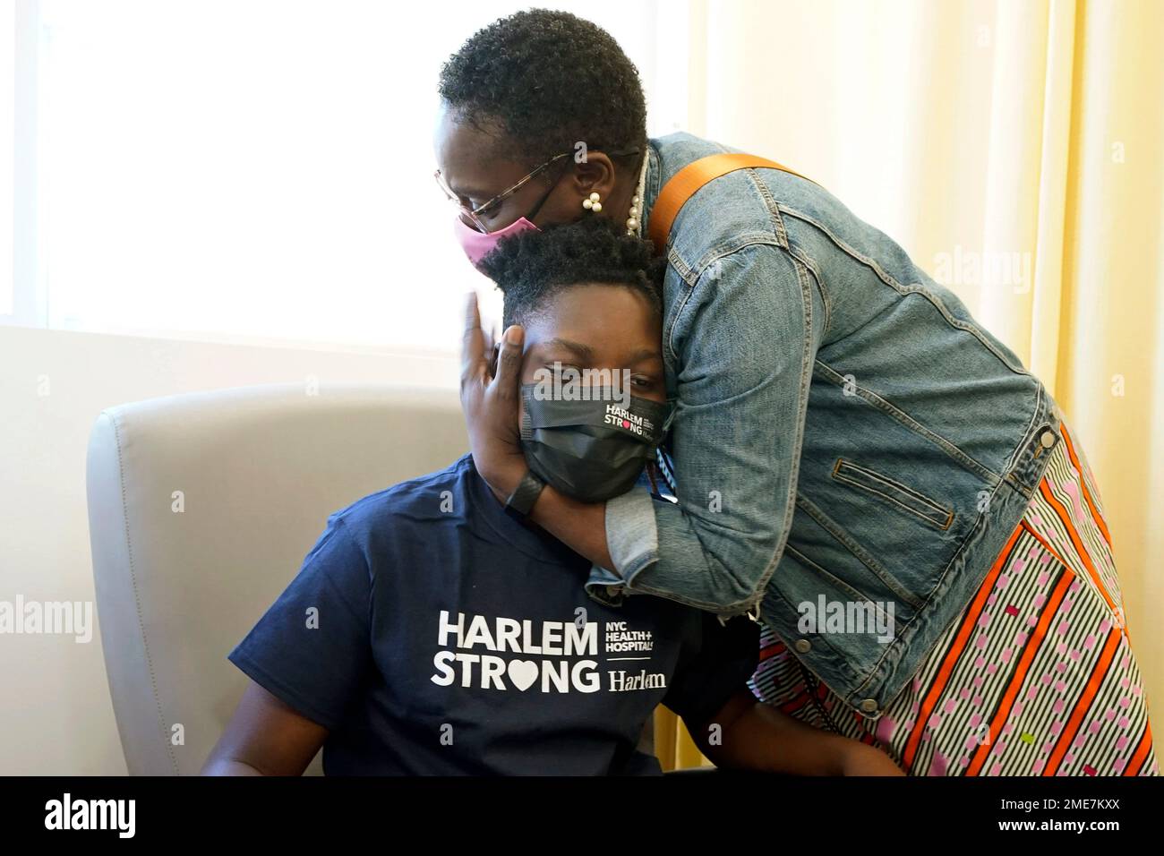 FILE - In this May 13, 2021, file photo, Julian Boyce, 14, gets a hug ...