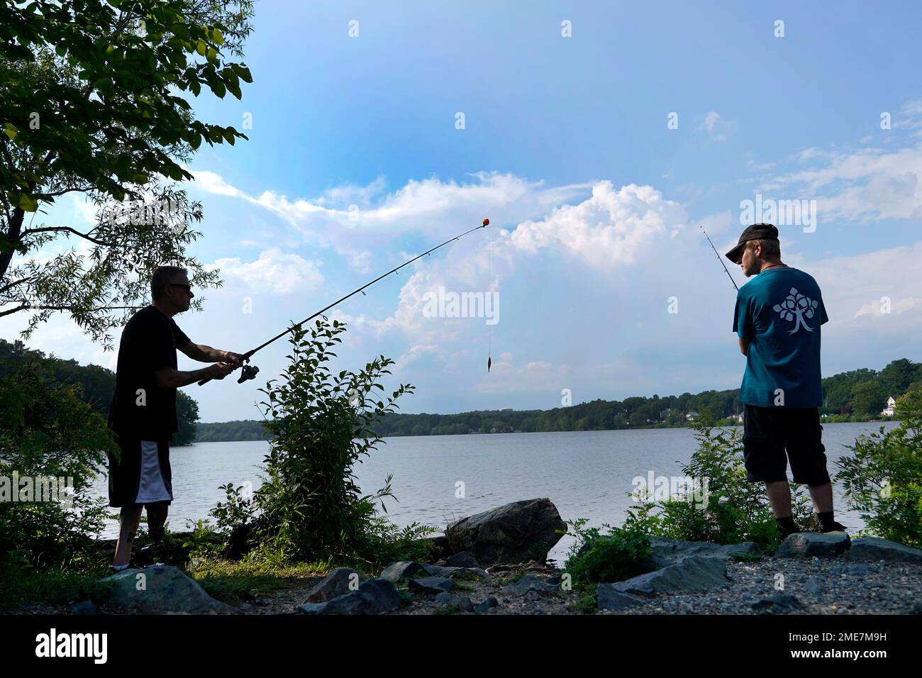 Chris Marks, left, and his son, Brendan, fish for bass at Horn Pond on ...