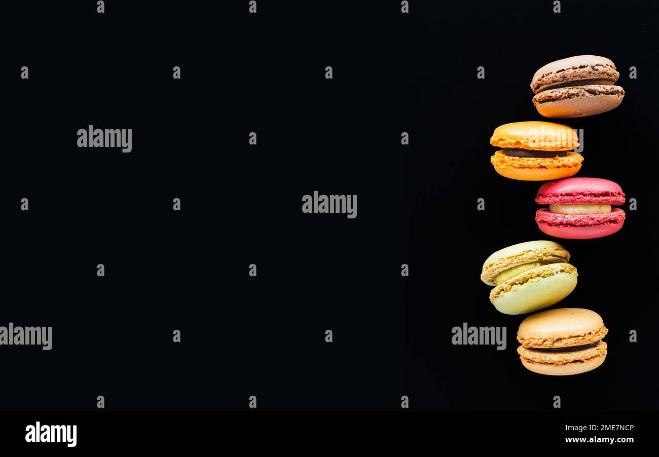 Colorful Macaron Cookie Border on Black Background Stock Photo - Alamy