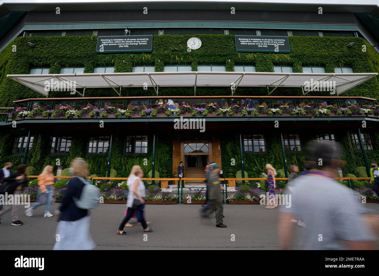 People walk past the front entrance to Centre Court on day nine of the ...